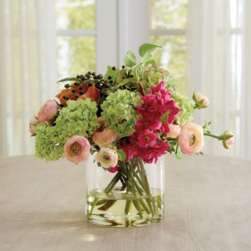 Mixed Buttercup Floral Arrangement with Anemone & Berries in Glass Vase